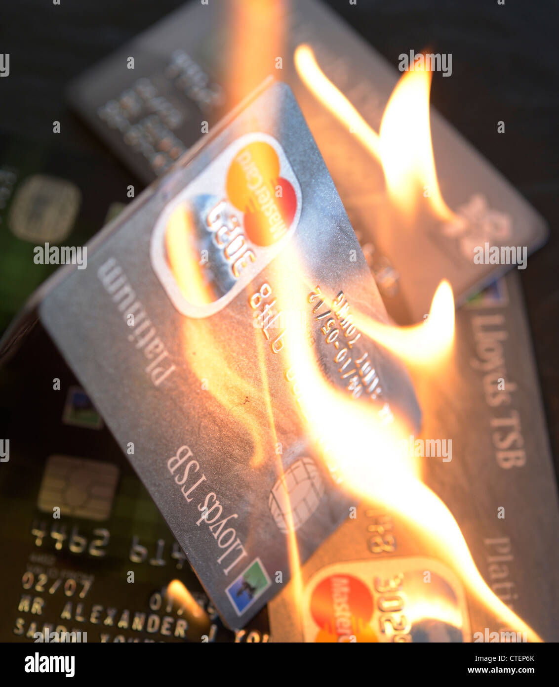 Selection of credit cards on fire Stock Photo - Alamy