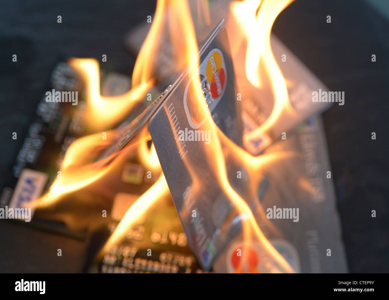 Selection of credit cards on fire Stock Photo - Alamy