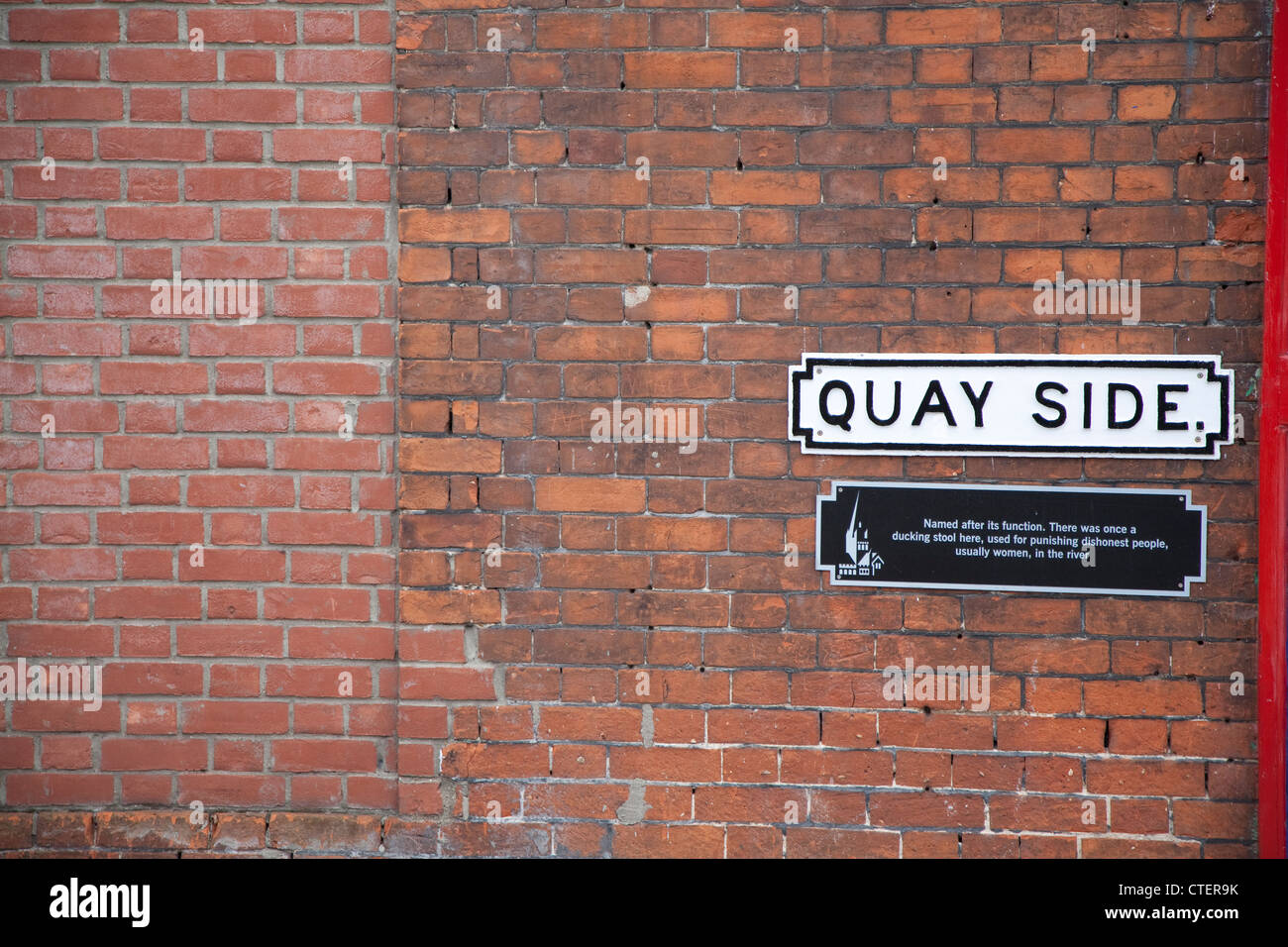 Quay Side street sign on red brick wall Stock Photo - Alamy