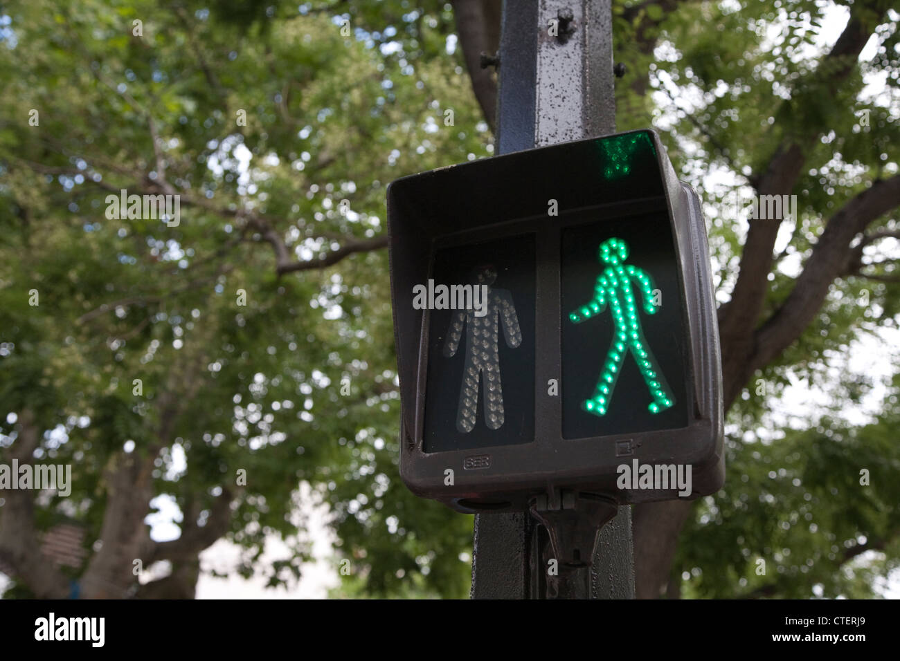 Green man pedestrian traffic signal for crossing the road in Paris ...