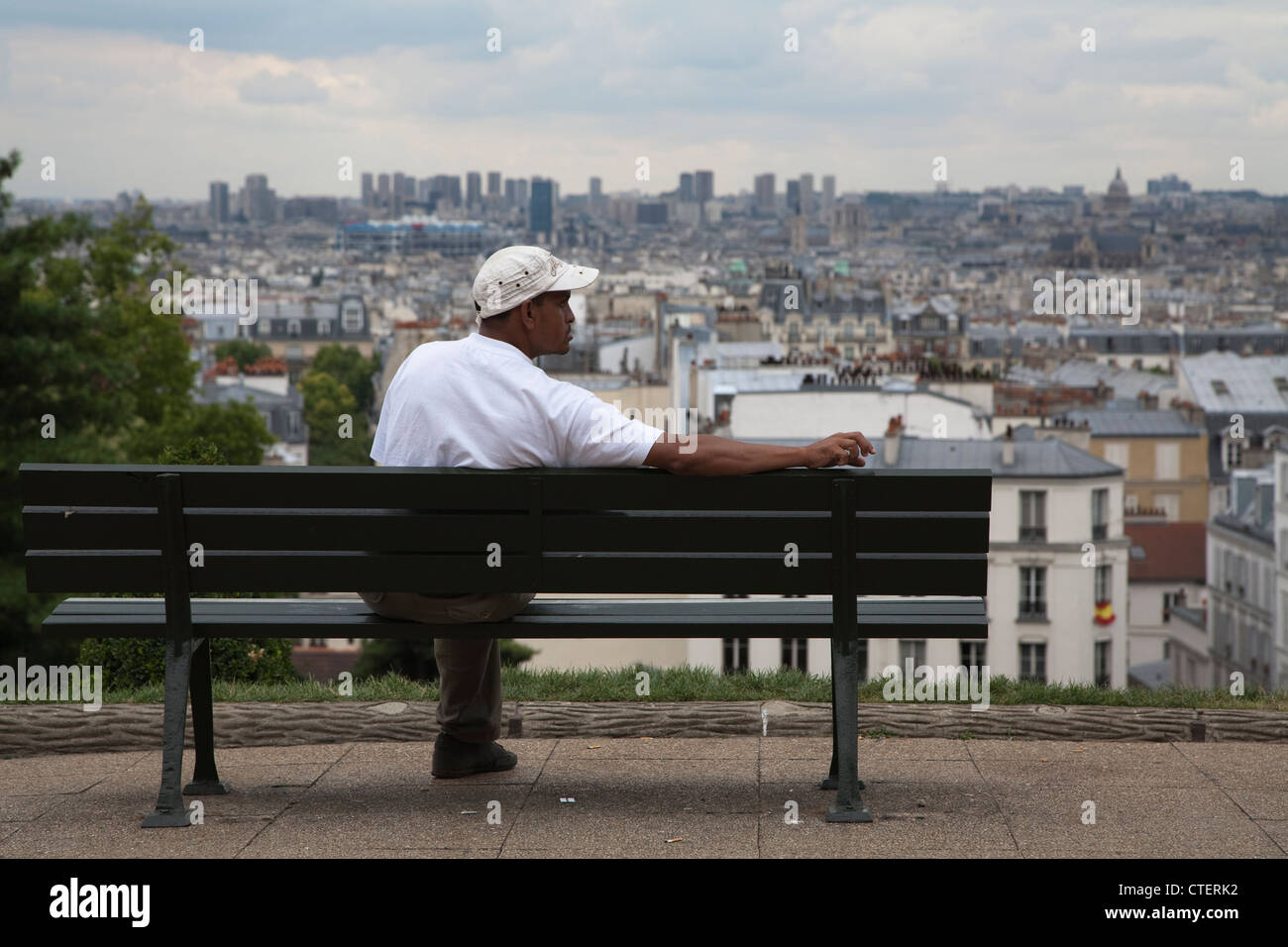 Man sitting on bench in Montmartre over looking Paris city view Stock ...