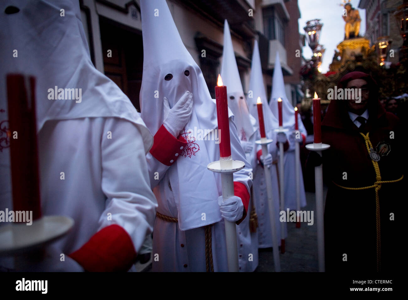 Penitents hold candles during the procession of Our Father Jesus of ...