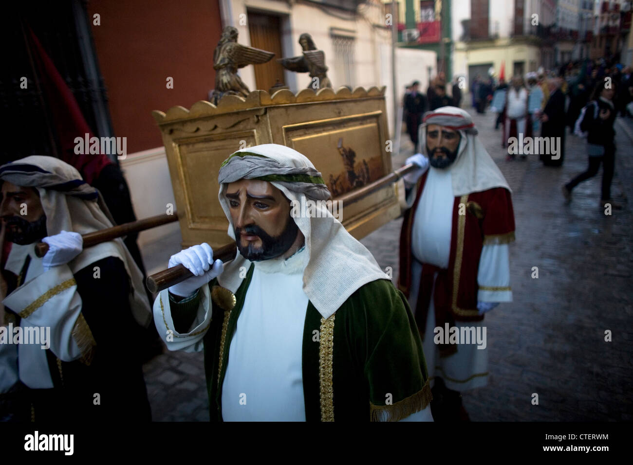 Masked men dressed as biblical characters carry a representation of the ...