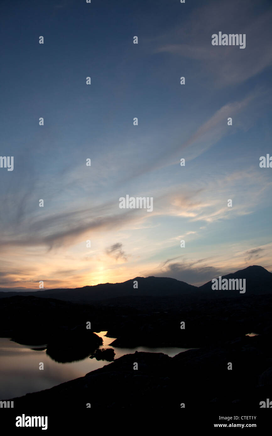 Isle of Harris, Scotland. Silhouetted sunset view of Loch Udromuil on ...