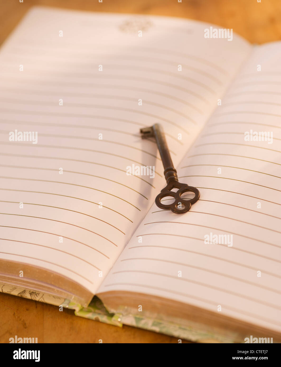 Close up of open notebook with key, studio shot Stock Photo - Alamy