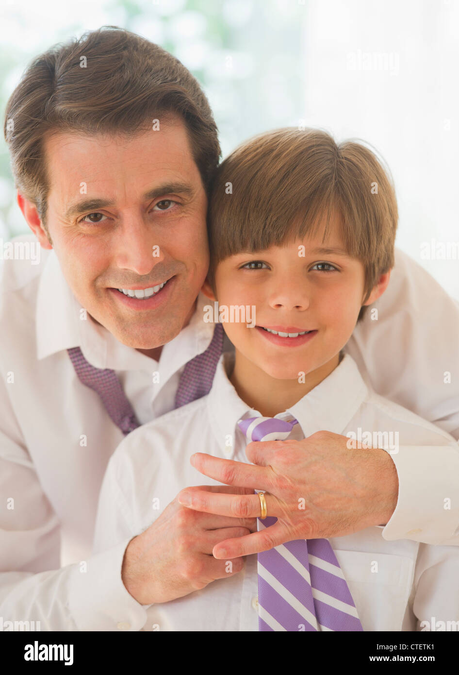 USA, New Jersey, Jersey City, Father helping son (10-11 years) to tie ...