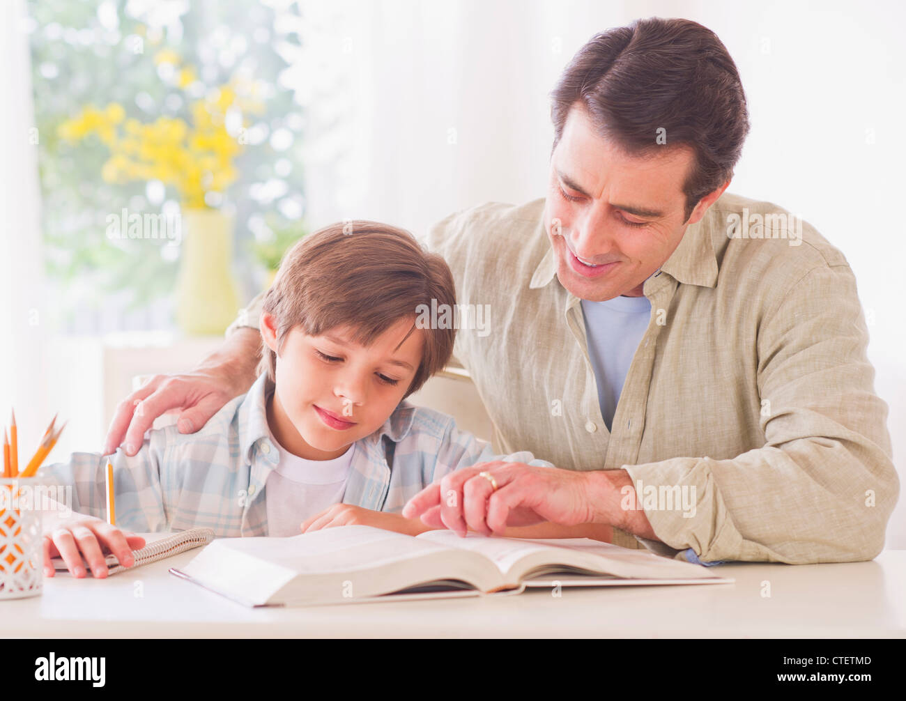 USA, New Jersey, Jersey City, Father helping son (10-11 years) with his ...