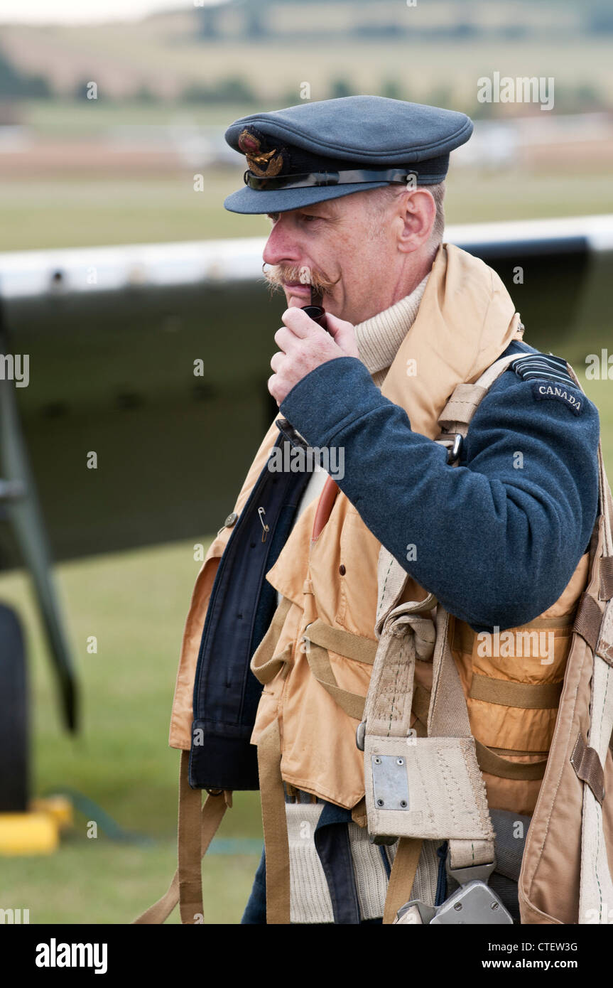 Pilot in period flying gear, with handlebar moustache and pipe, at the ...