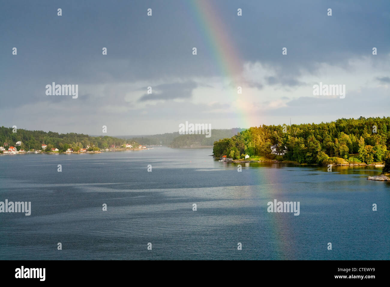 rainbow in rain during sunshine in Baltic sea Stock Photo - Alamy