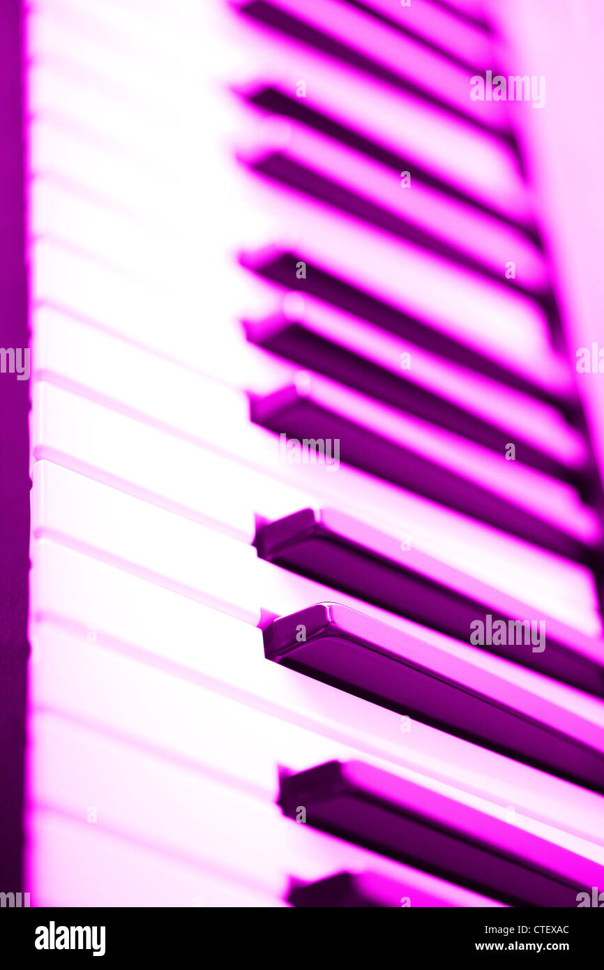 An electronic keyboard with magenta filter cast Stock Photo - Alamy
