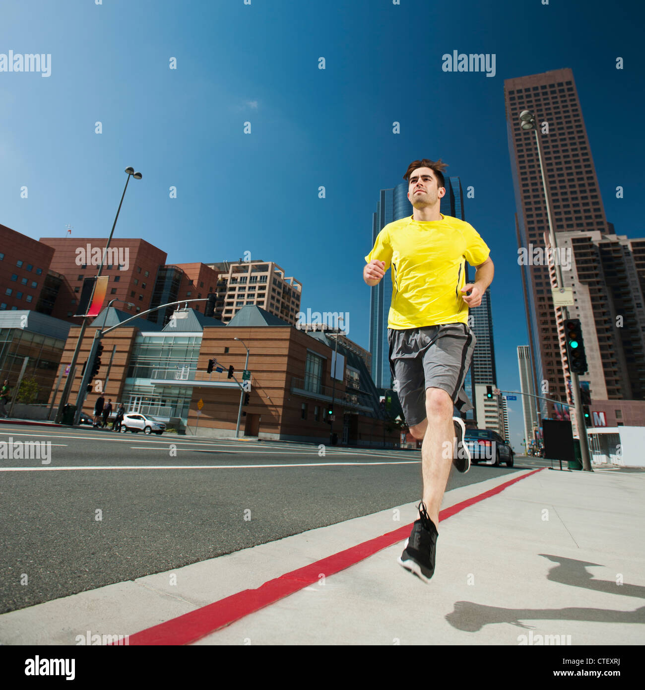 USA, California, Los Angeles, Young man running on city street Stock ...