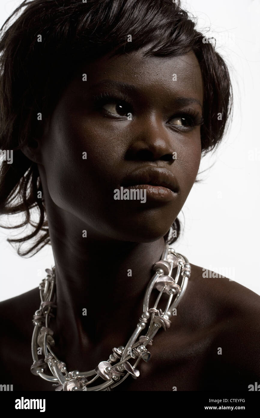 Portrait of young woman in necklace Stock Photo - Alamy