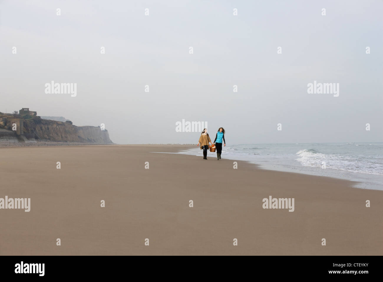 France, Pas-de-Calais, Escalles, Two women strolling on empty beach ...