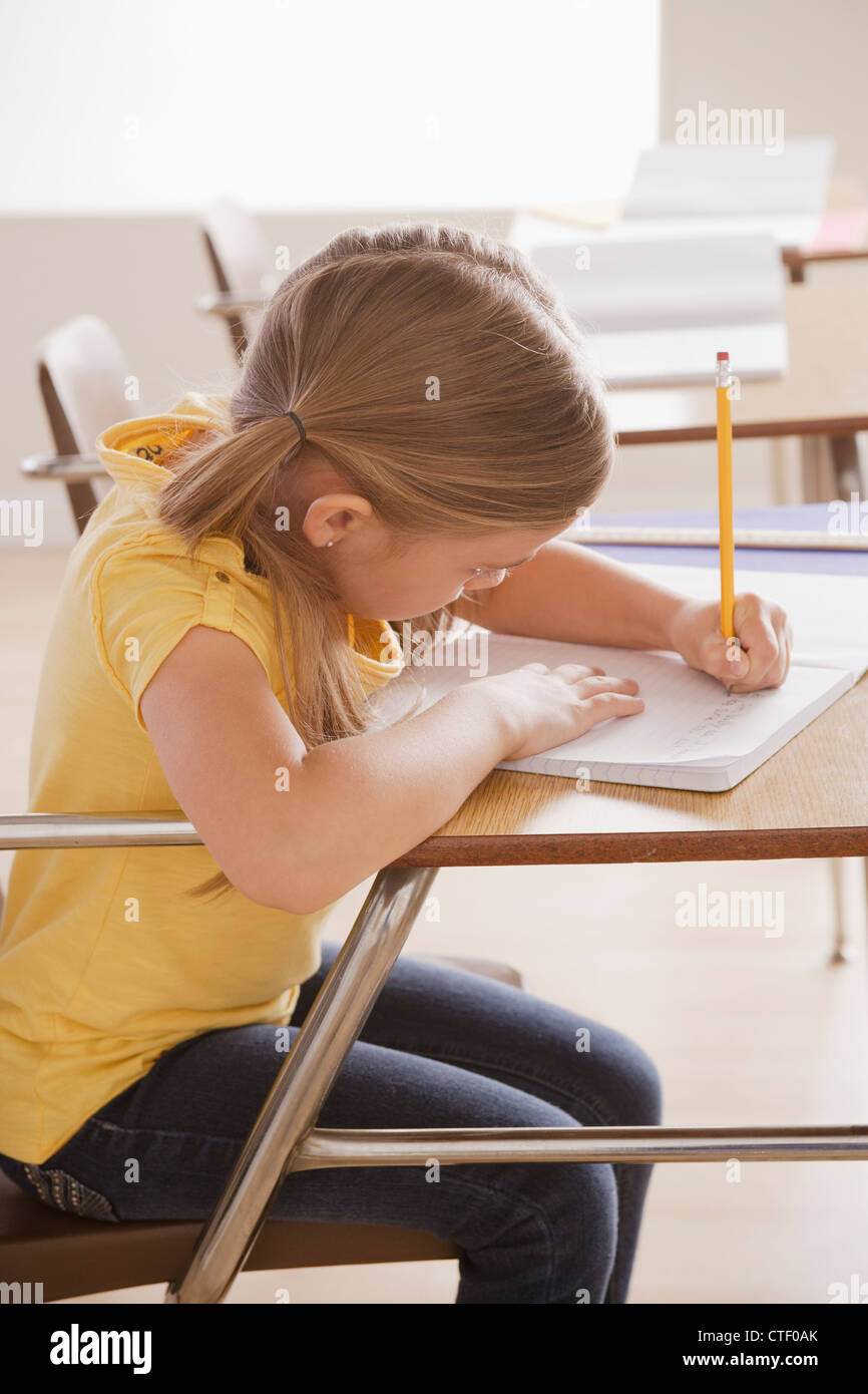 USA, California, Los Angeles, Schoolgirl writing in notebook Stock ...