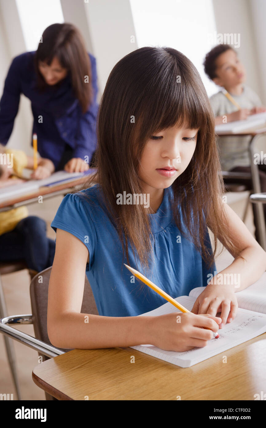 USA, California, Los Angeles, Schoolgirl focused on writing Stock Photo ...
