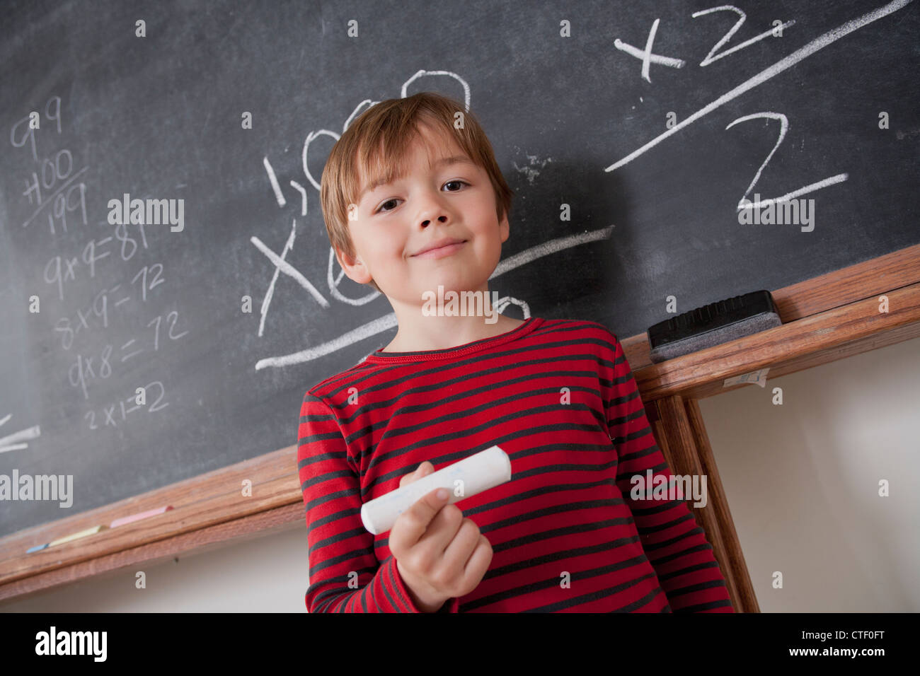 USA, California, Los Angeles, Schoolboy writing on blackboard Stock ...