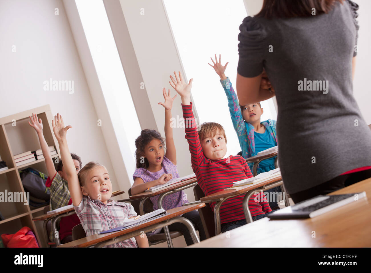 Kids Raising Hands Classroom Stock Photos & Kids Raising Hands ...
