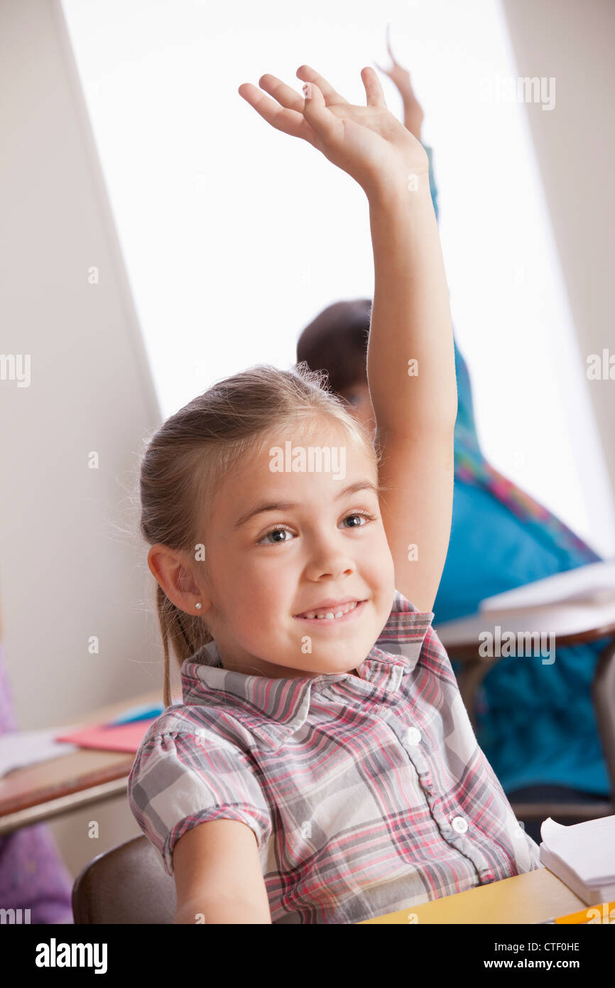 USA, California, Los Angeles, Pupils in classroom raising hands Stock ...
