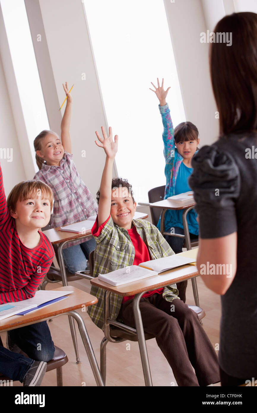 USA, California, Los Angeles, Pupils in classroom raising hands Stock ...