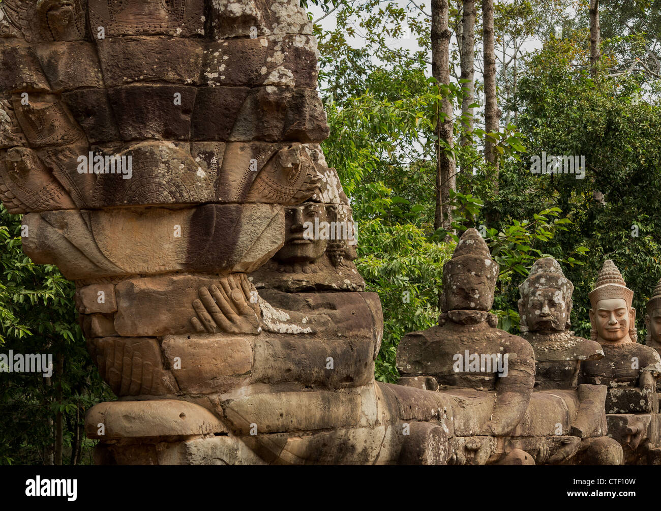 South gate to angkor thom in Cambodia is lined with warriors and demons ...