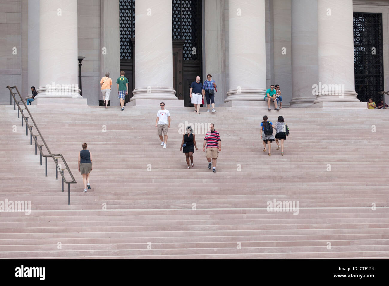People walking down marble steps Stock Photo - Alamy