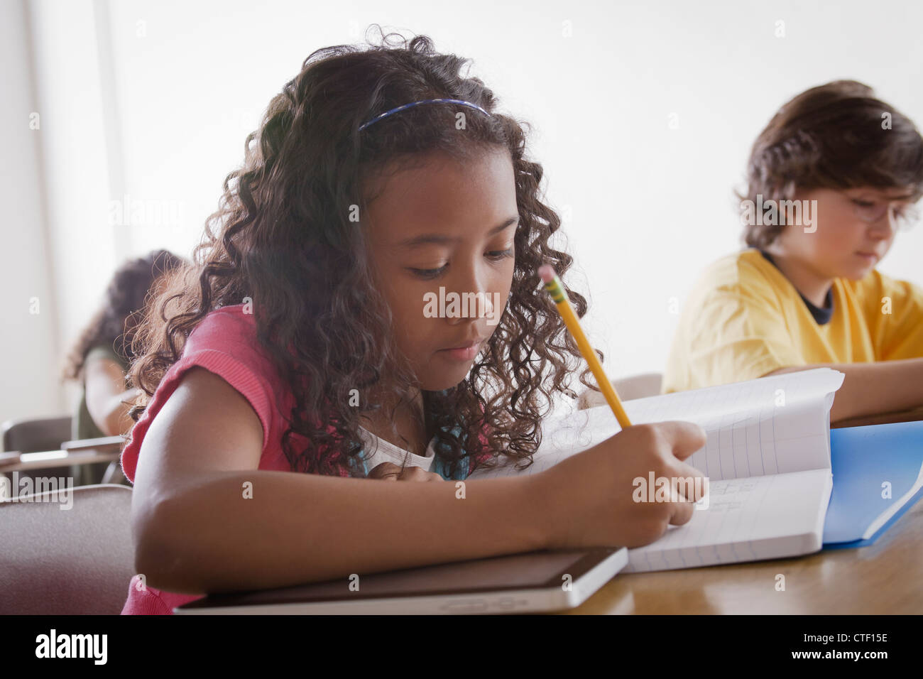 USA, California, Los Angeles, Portrait of schoolgirl (10-11) writing ...