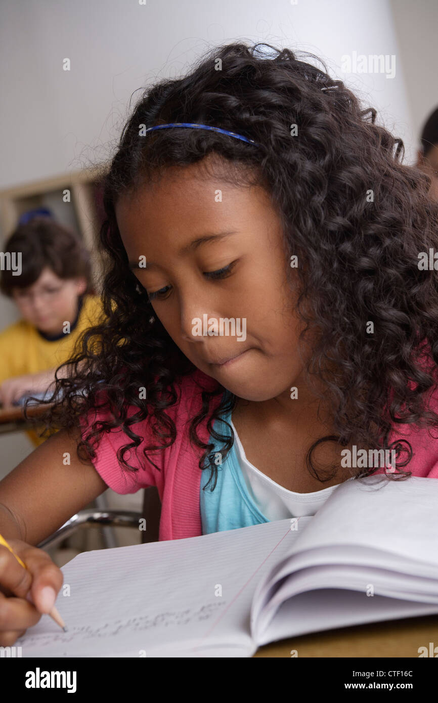 Boy biting pencil hi-res stock photography and images - Alamy