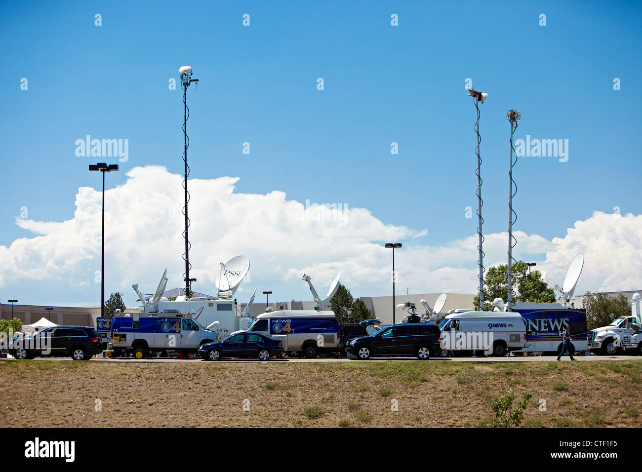 Local news stations set up broadcasting vehicles near the Colorado ...