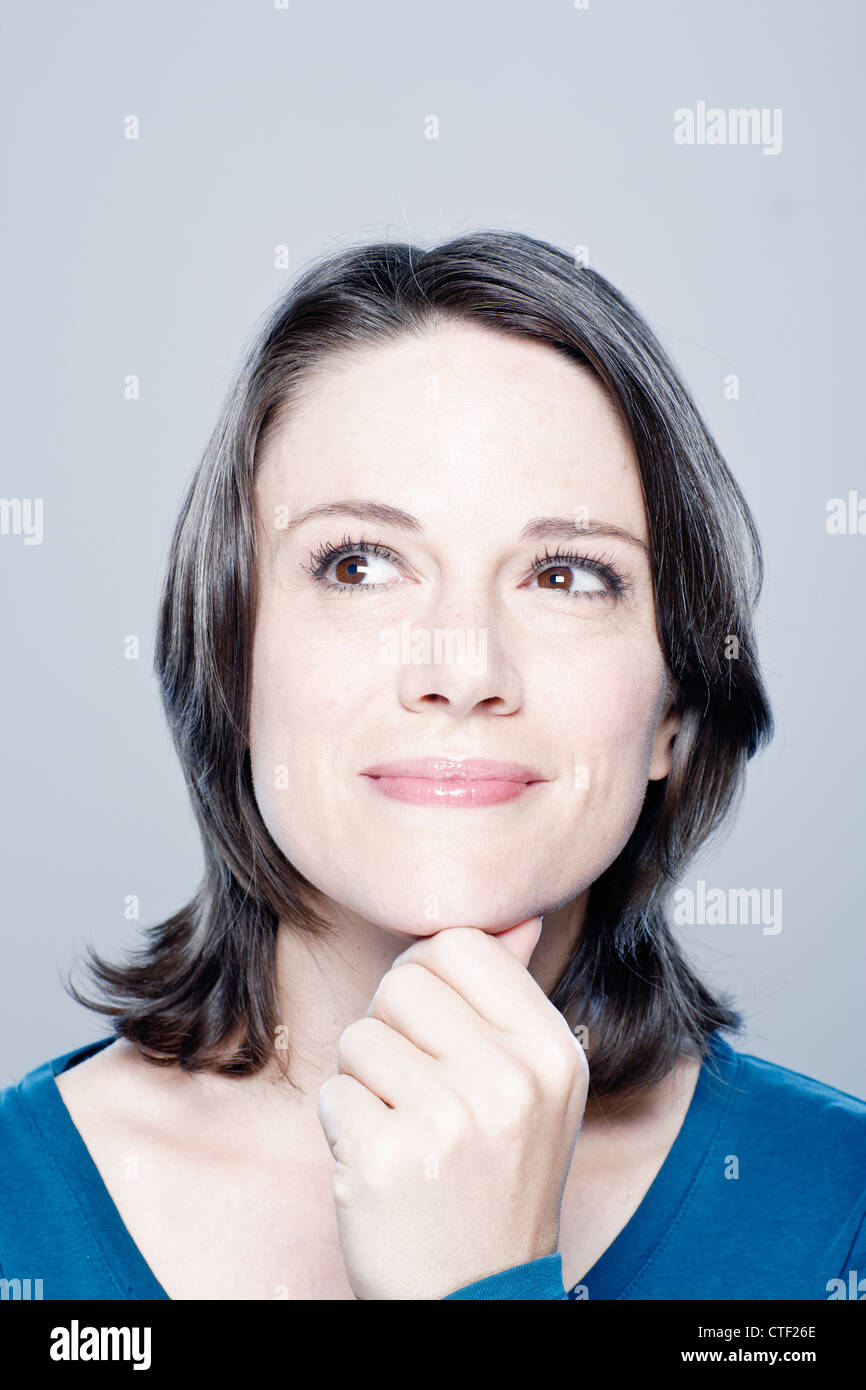 Portrait of thoughtful mid adult woman, studio shot Stock Photo - Alamy