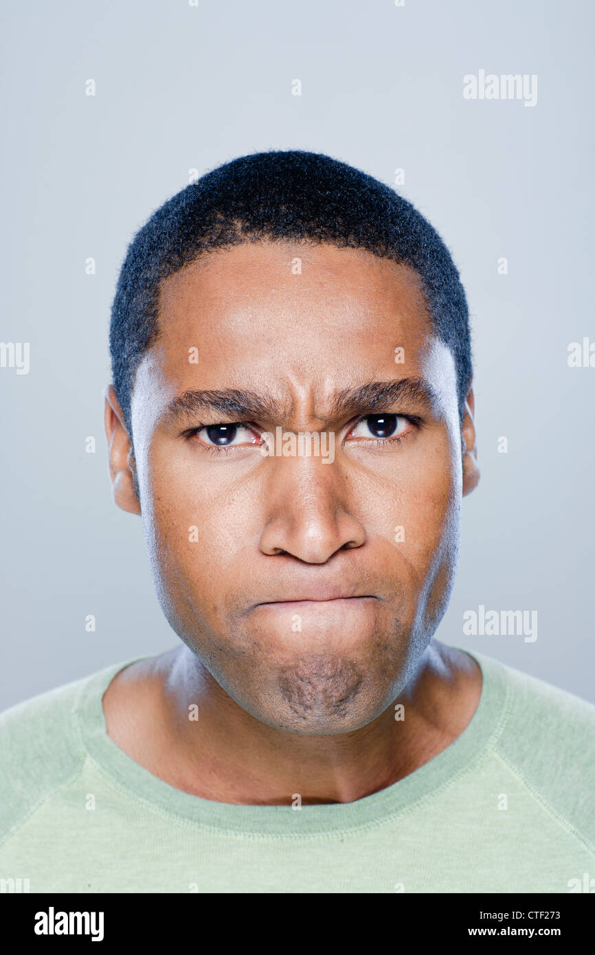 Portrait of young angry man, studio shot Stock Photo - Alamy