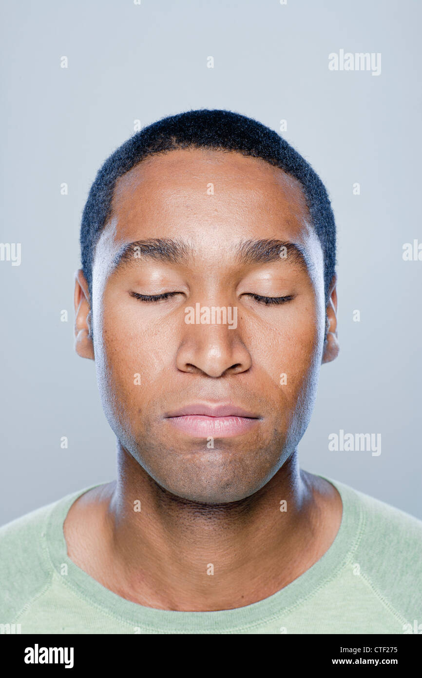 Portrait of young man with eyes closed, studio shot Stock Photo - Alamy