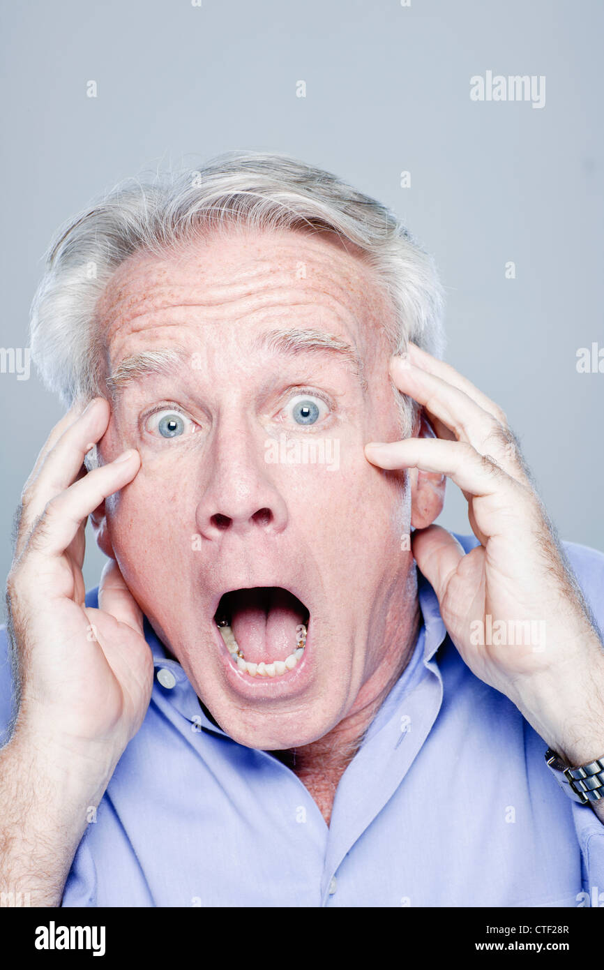 Portrait of scared senior man, studio shot Stock Photo - Alamy