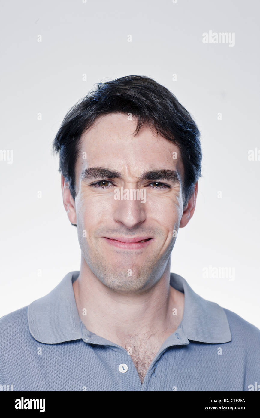 Portrait of confused man, studio shot Stock Photo - Alamy