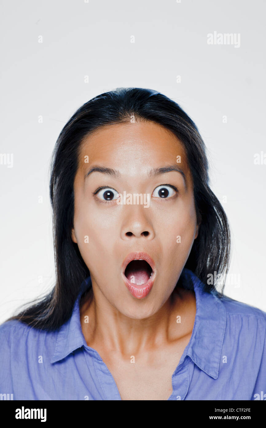Portrait of surprised young woman, studio shot Stock Photo - Alamy