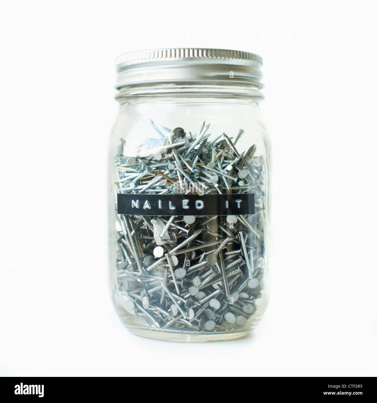 Nails in jar, studio shot Stock Photo - Alamy