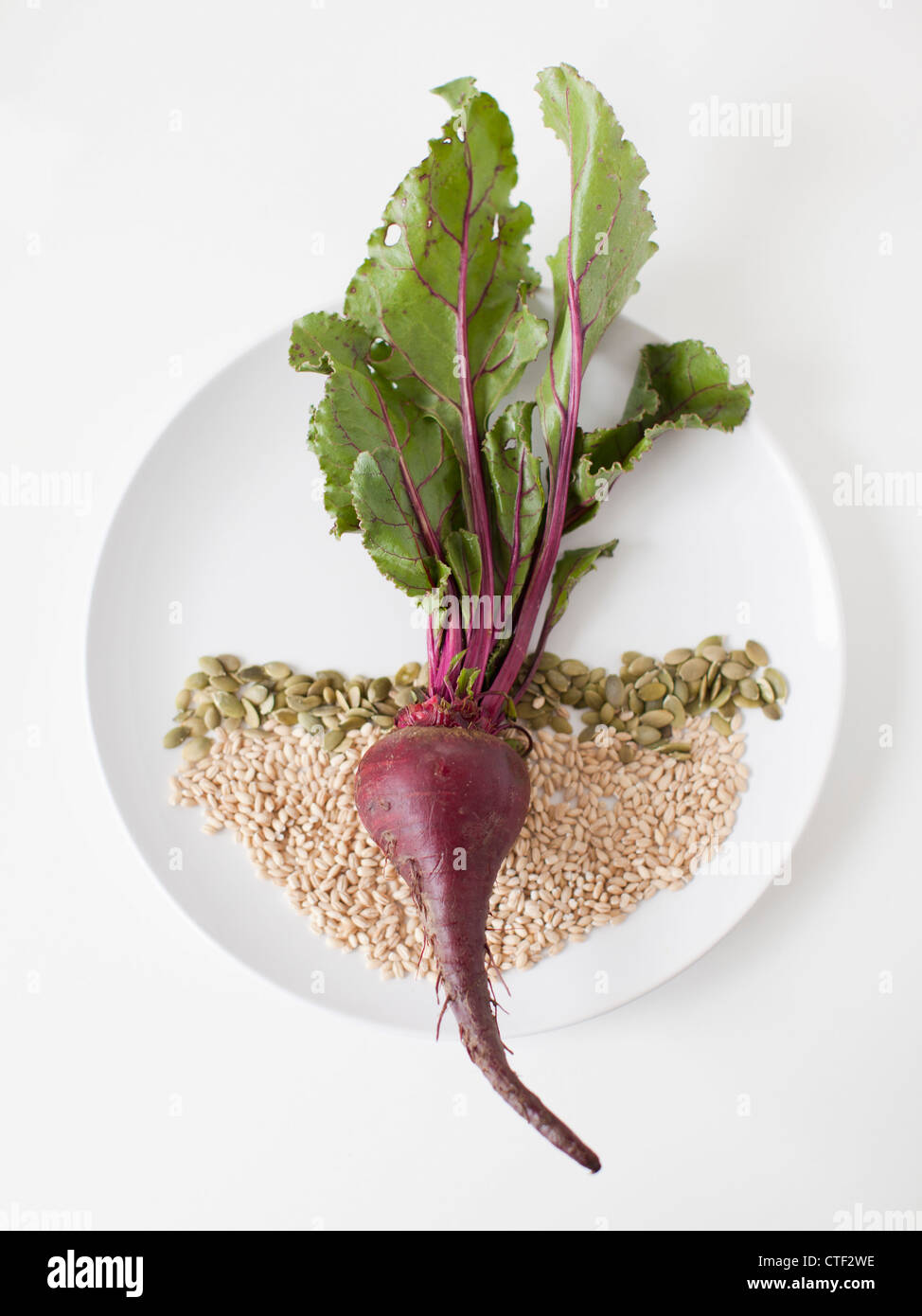 Beetroot and seeds on plate, studio shot Stock Photo - Alamy