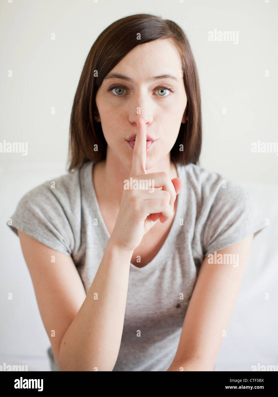 Portrait of secretive young woman Stock Photo - Alamy