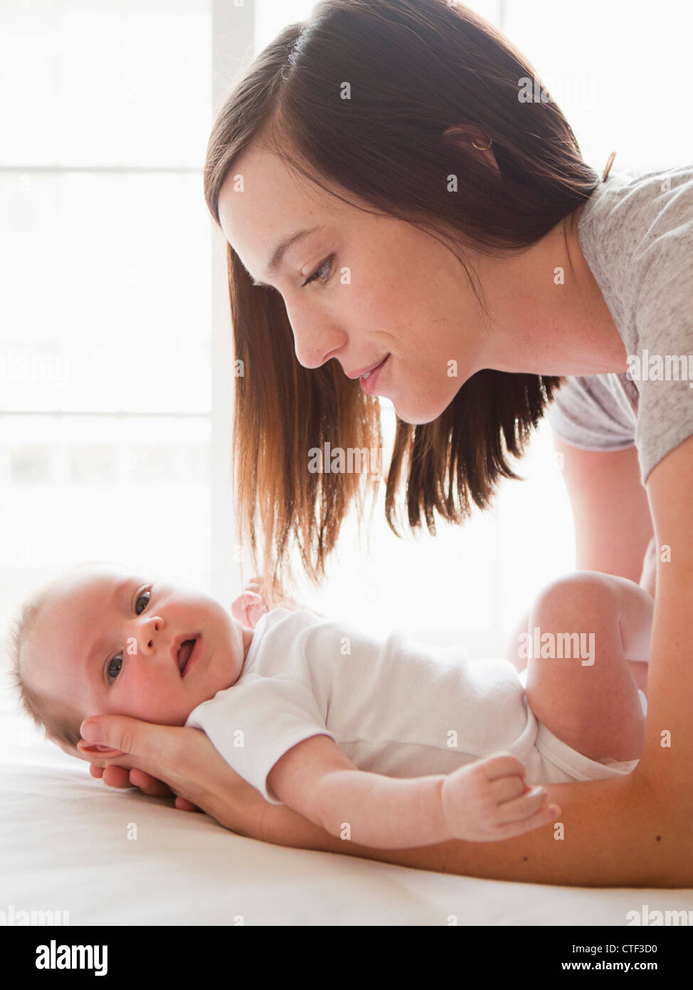 Mother changing baby girl (2-5 months Stock Photo - Alamy