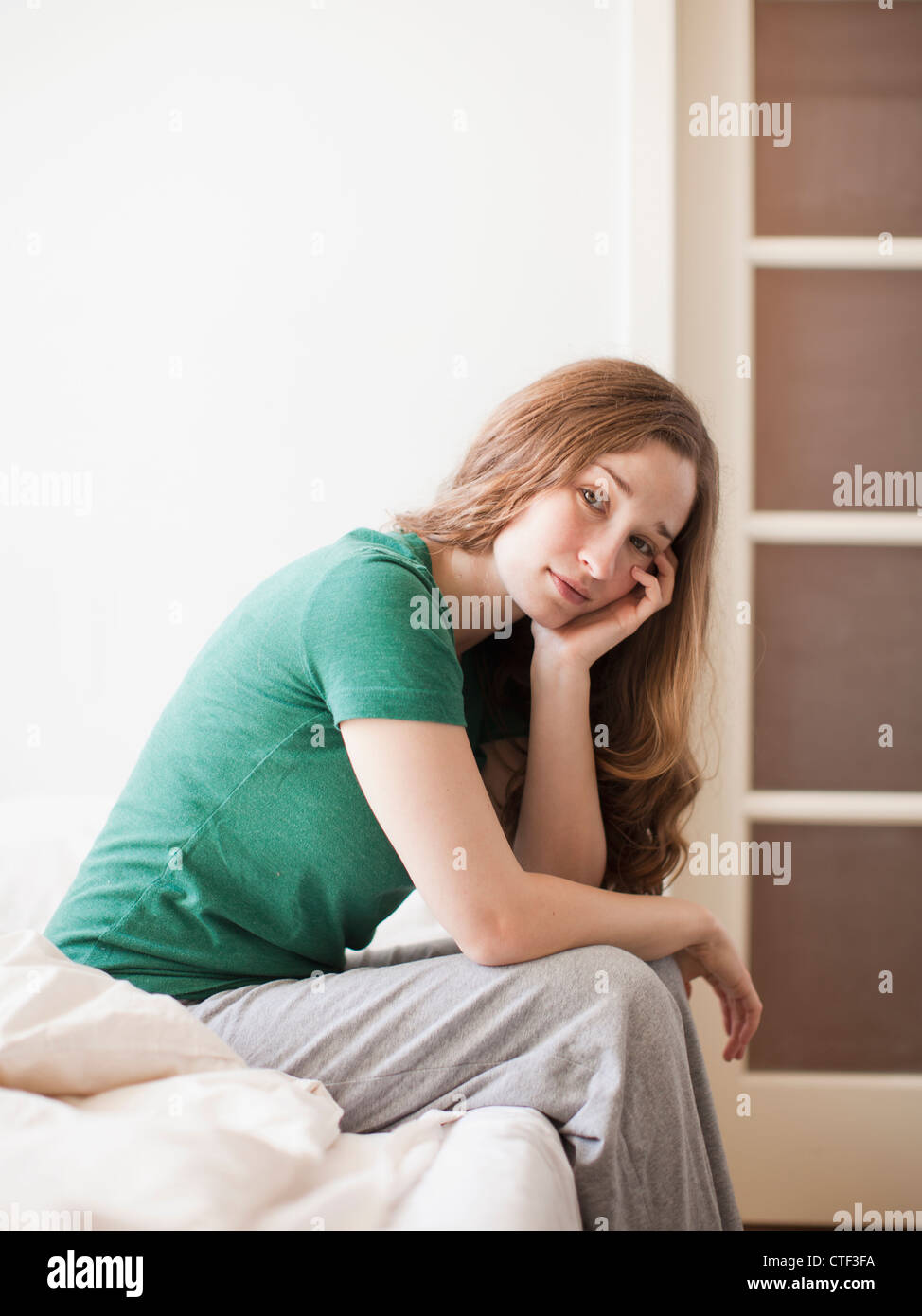 USA, Utah, Salt Lake City, Sad young woman sitting in bed Stock Photo ...