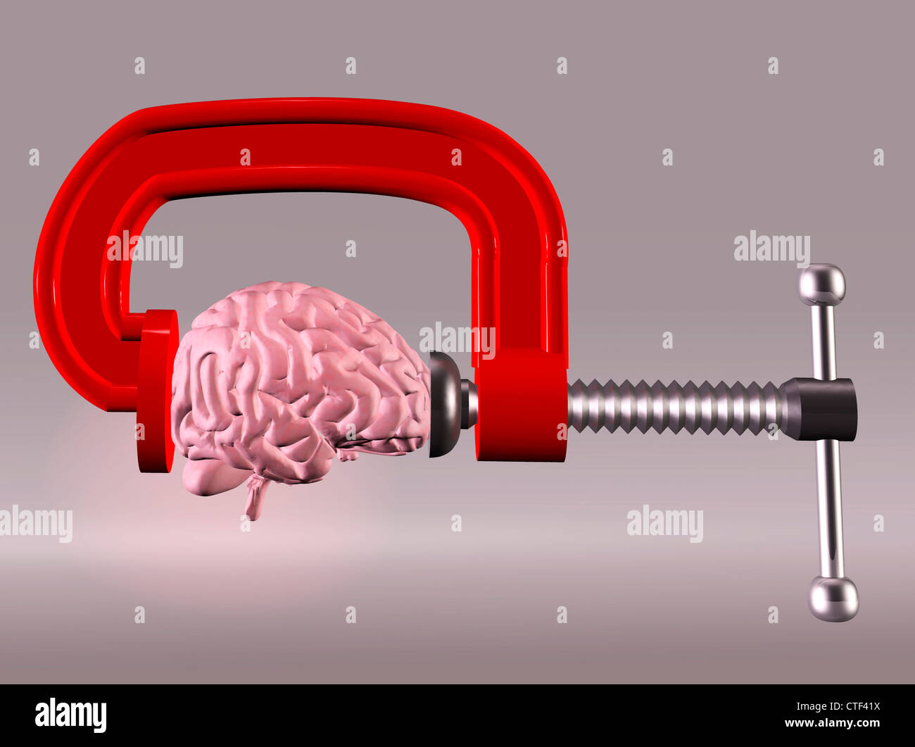 Studio shot of brain in squeezed by clamp Stock Photo - Alamy
