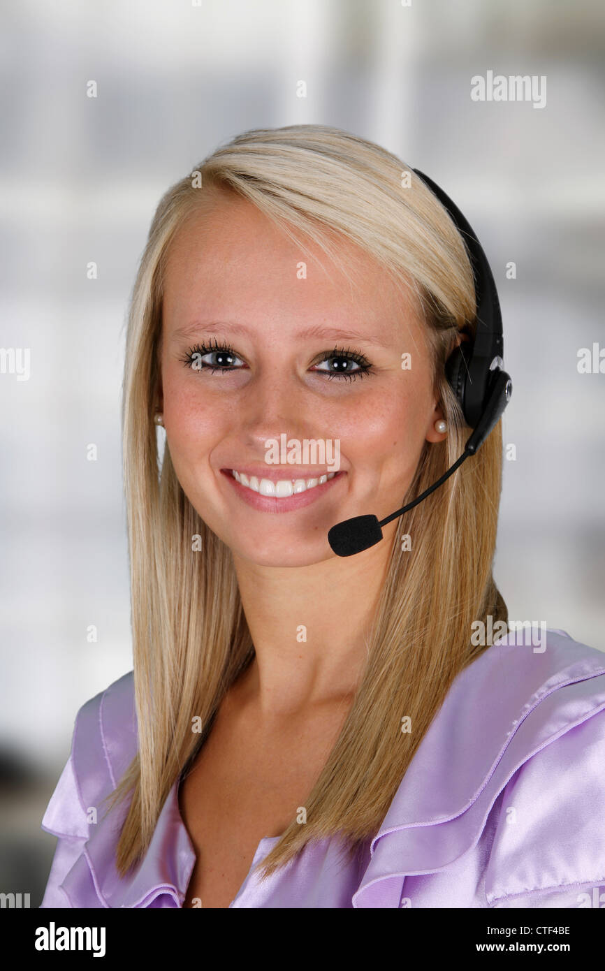 Young woman giving help as a customer service employee Stock Photo - Alamy