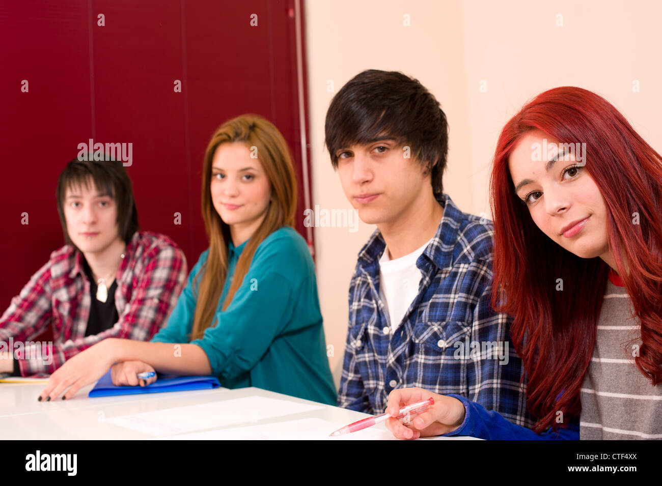 Teenage students in classroom looking at camera Stock Photo - Alamy