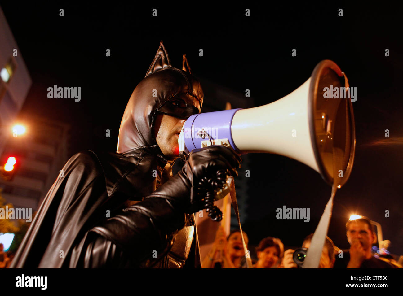 An Israeli demonstrator dressed in Batman outfit shouting anti ...