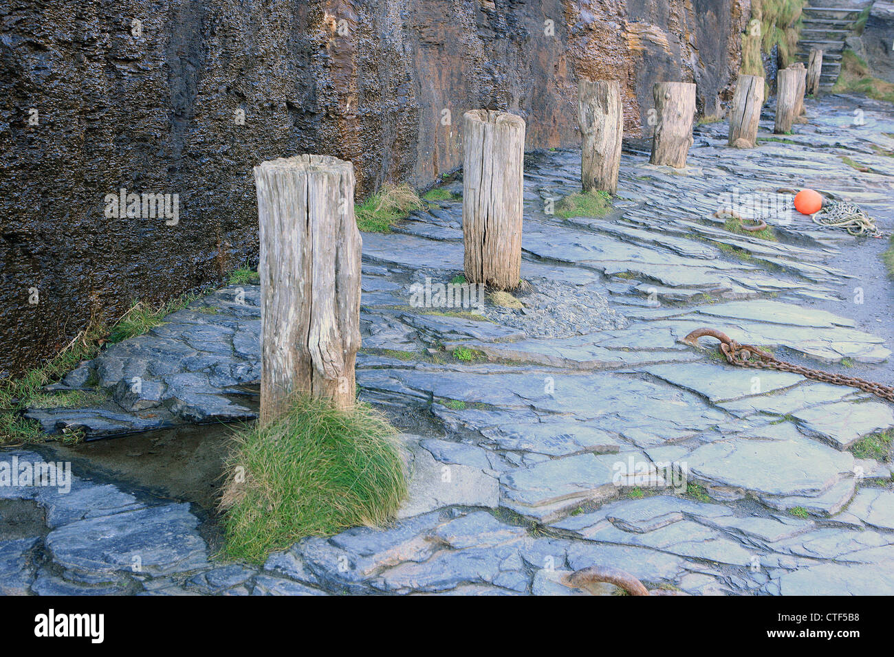 A row of bollards on the quayside around the harbour in the fishing ...