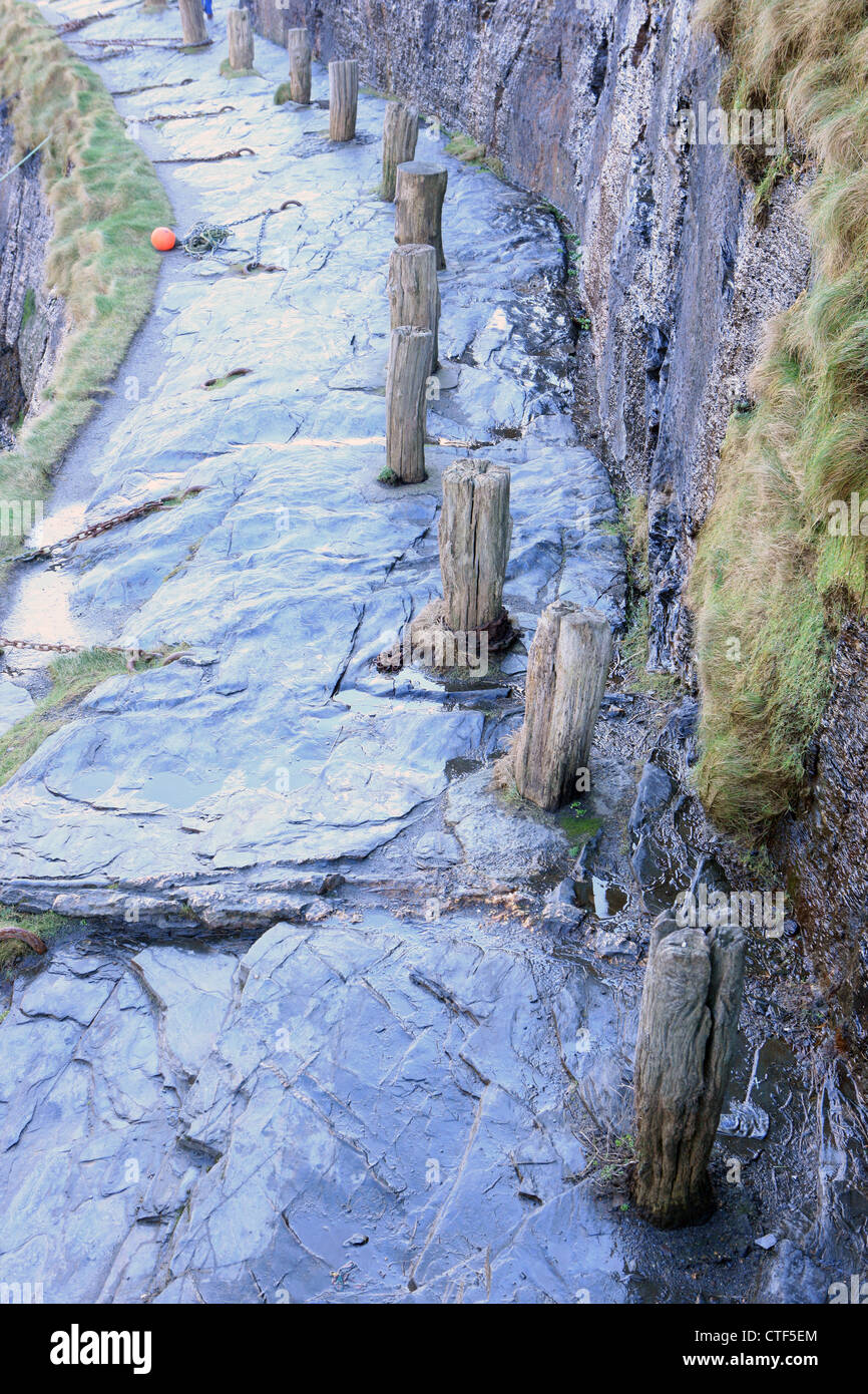A row of bollards on the quayside around the harbour in the fishing ...