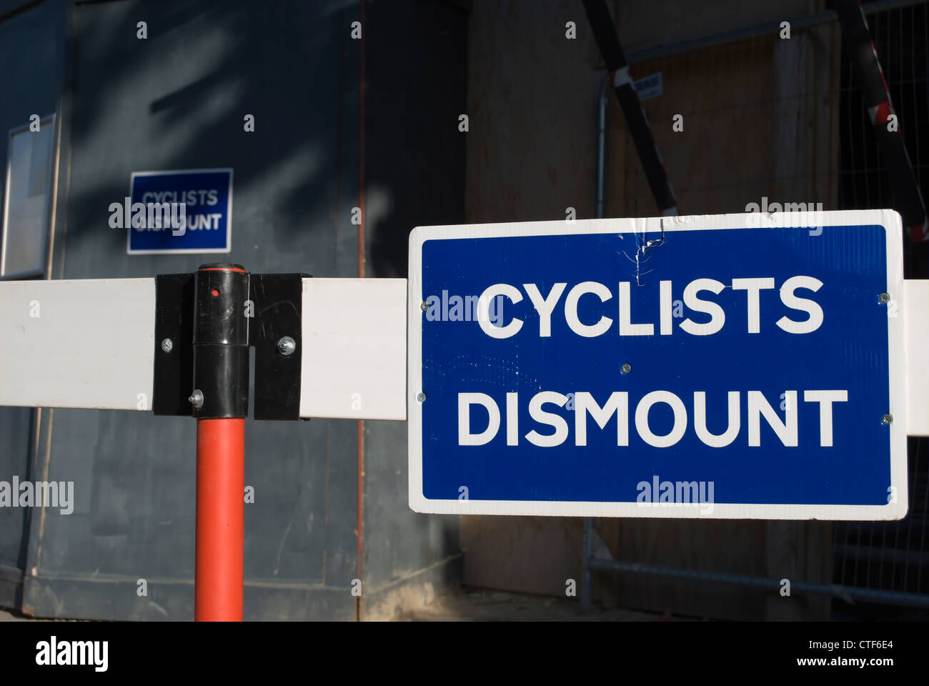 cyclists dismount sign on barriers in teddington, middlesex, england ...