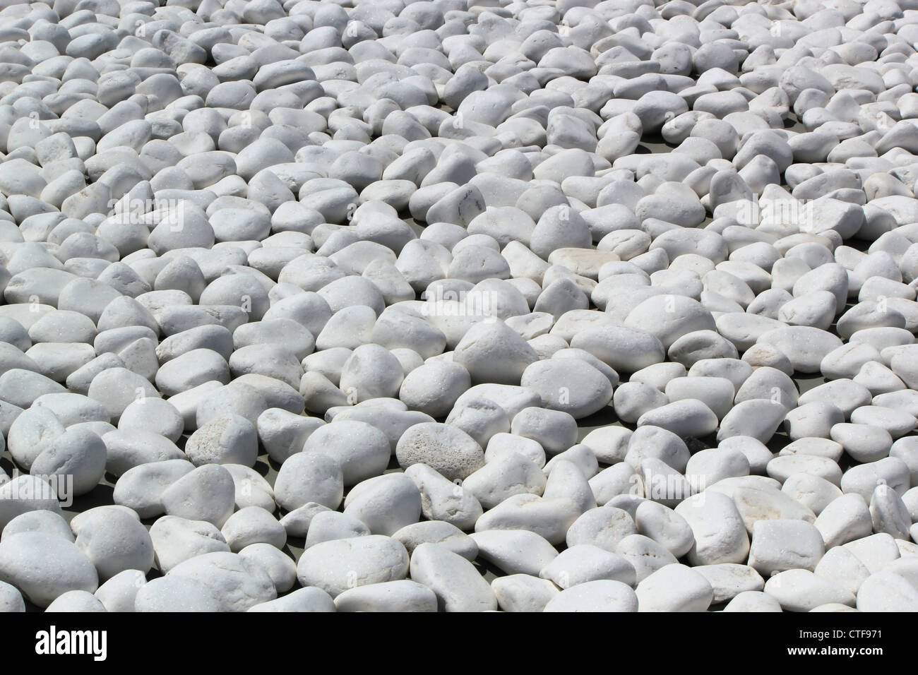 Many white stones as a background Stock Photo - Alamy