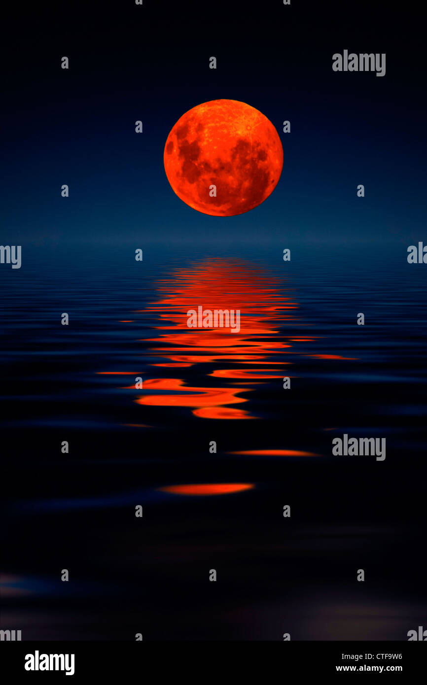 A red moon setting over a photoshop sea and reflection Stock Photo - Alamy