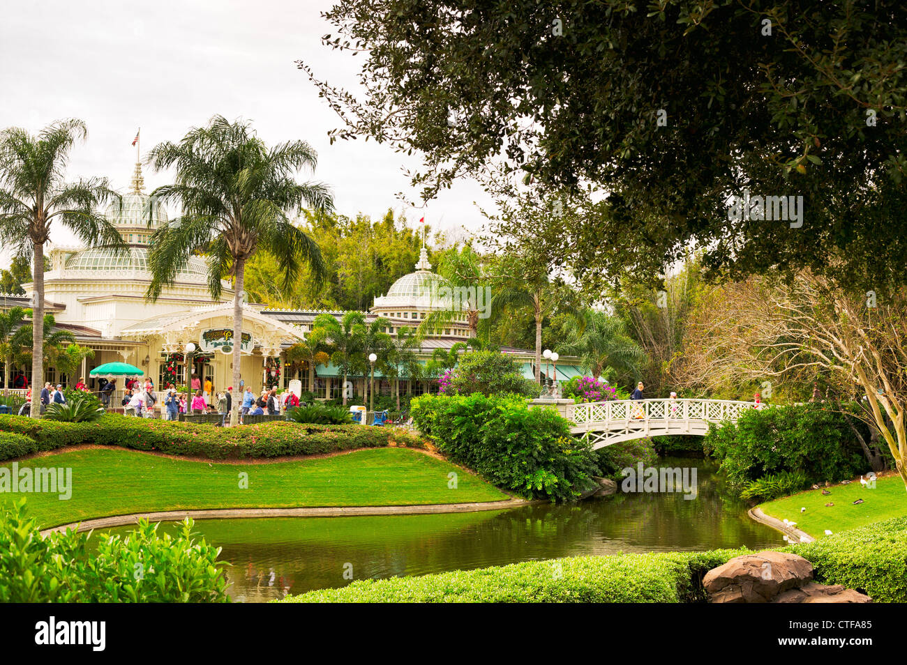 A tranquil scene with a bridge crossing a water feature leading to ...