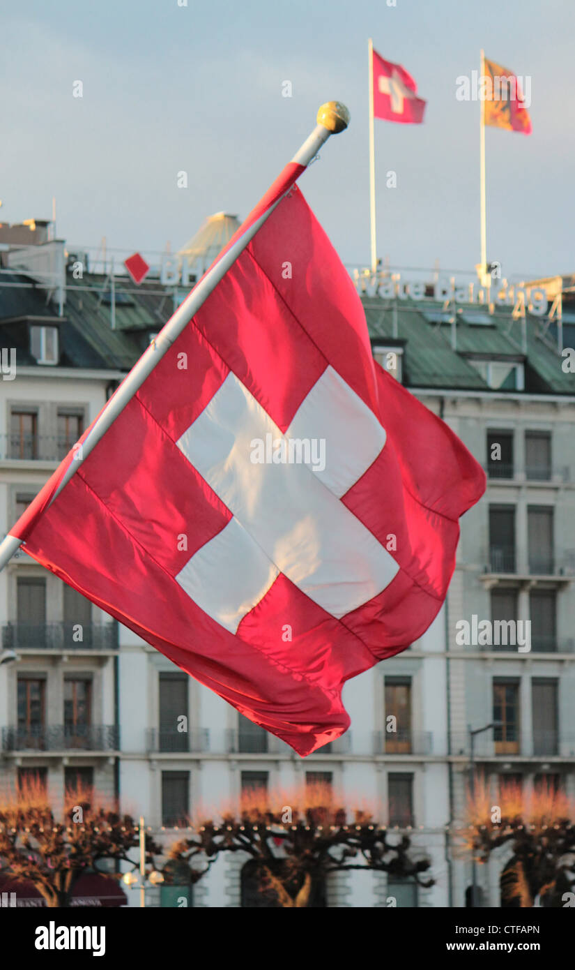 Swiss flag in front of Geneva building, Switzerland Stock Photo - Alamy